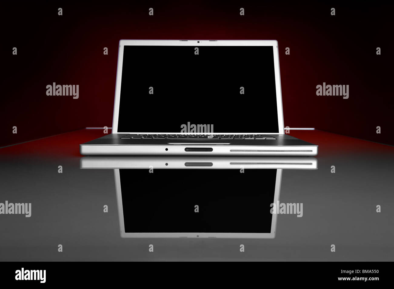 Image of a dark screen laptop on a glass table with reflection Stock ...