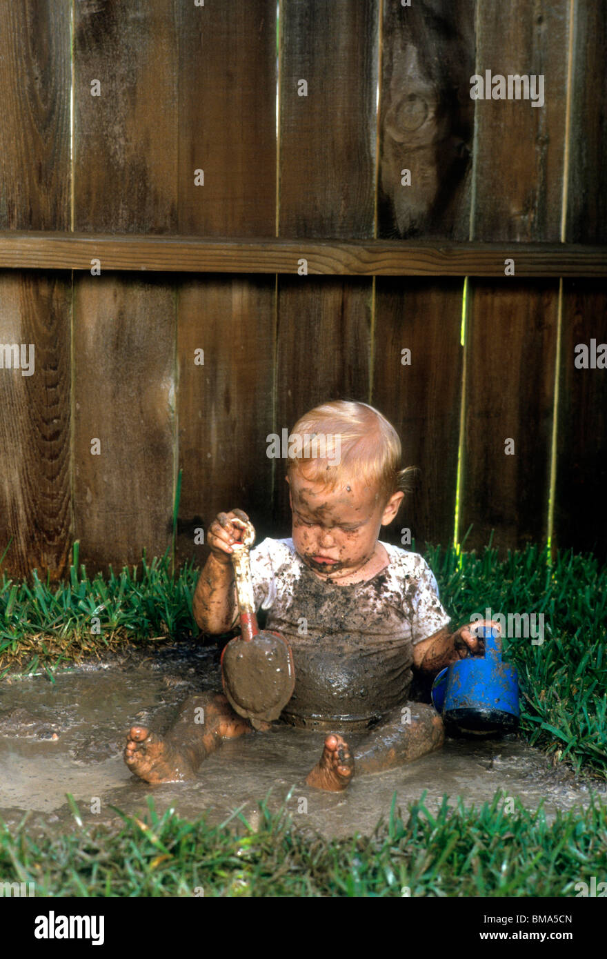 Baby playing in the mud Stock Photo - Alamy