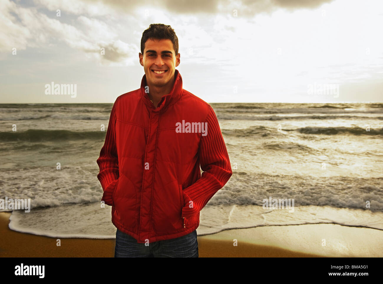 A Young Man Standing On A Beach Stock Photo - Alamy