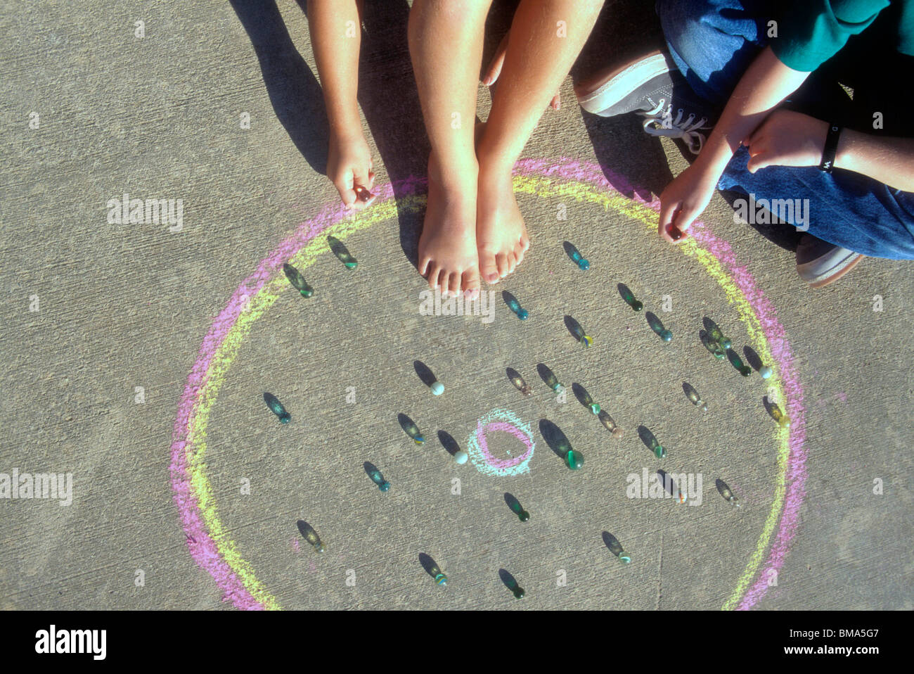 Two children playing marbles hi-res stock photography and images - Alamy