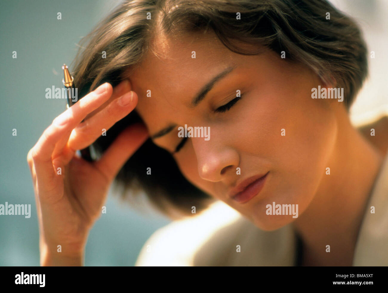 Business woman thinking. Or, has a headache Stock Photo - Alamy