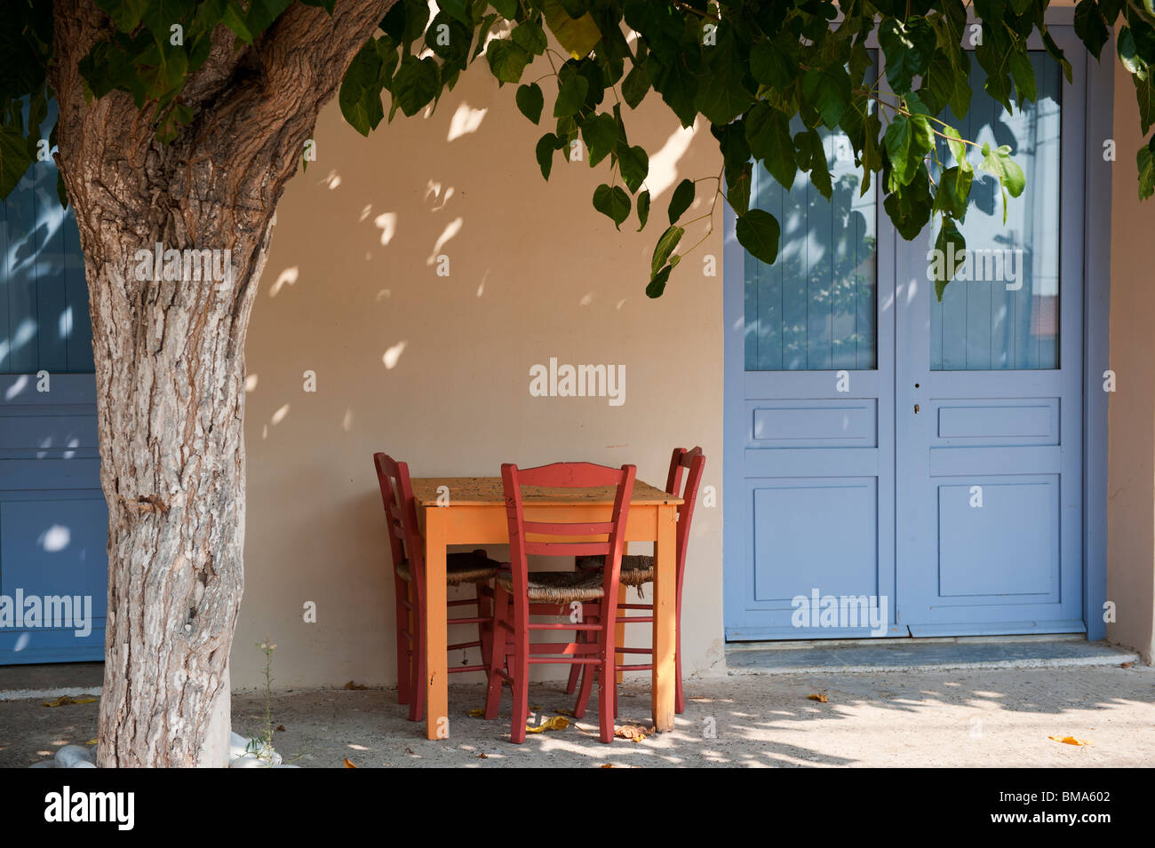 Greek furniture as terrace under the big tree Stock Photo - Alamy