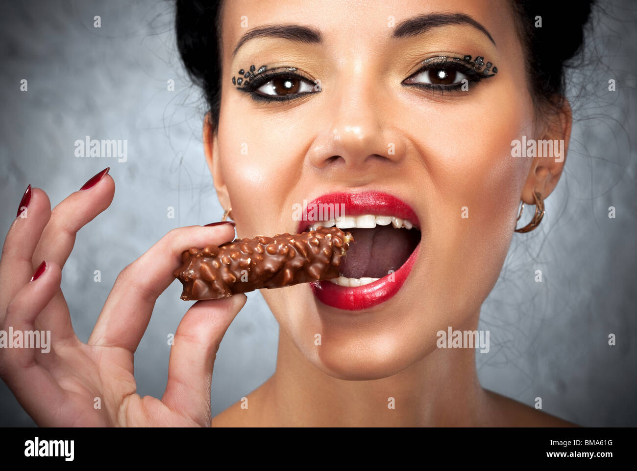 Young woman eating sweet portrait Stock Photo - Alamy