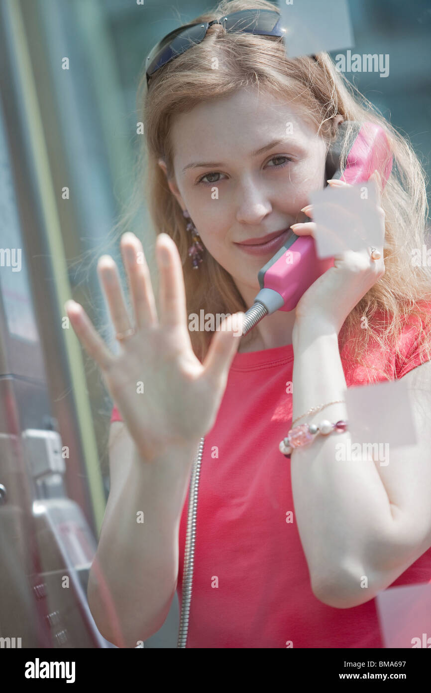 Young casual woman in call box. Focus on face Stock Photo - Alamy
