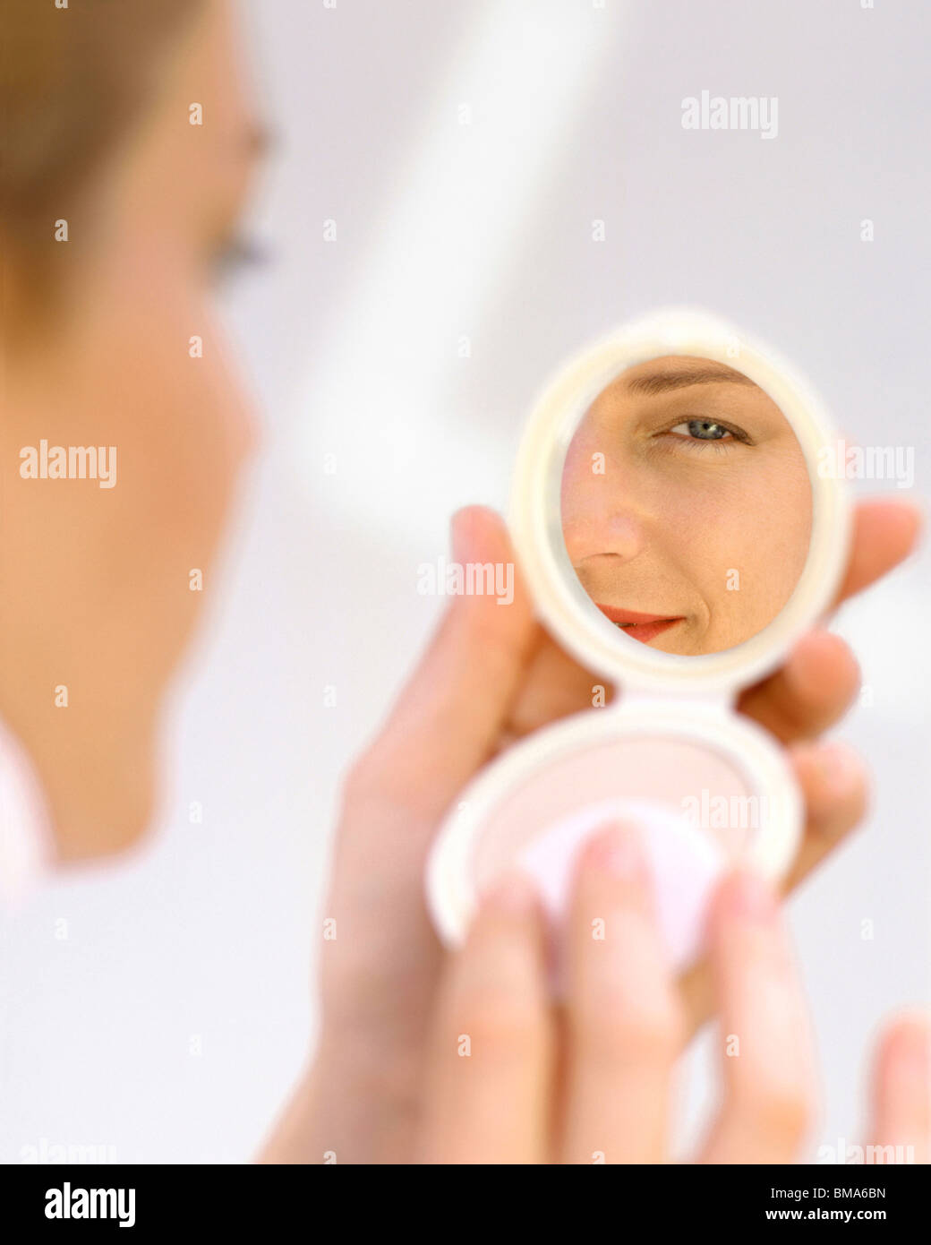 Applying makeup in compact mirror hi-res stock photography and images ...