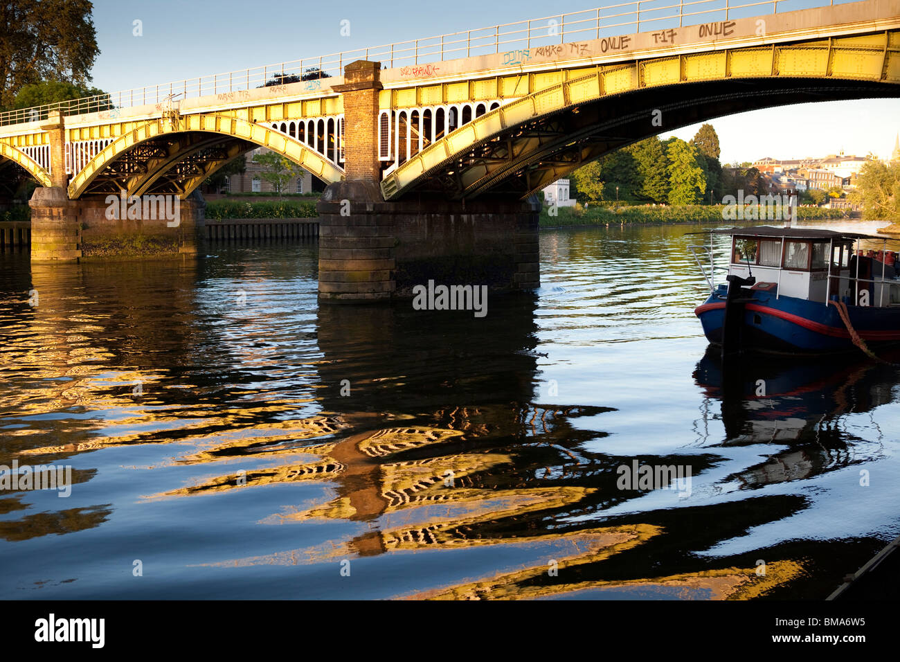 Richmond Railway Bridge over the River Thames lit by late afternoon ...