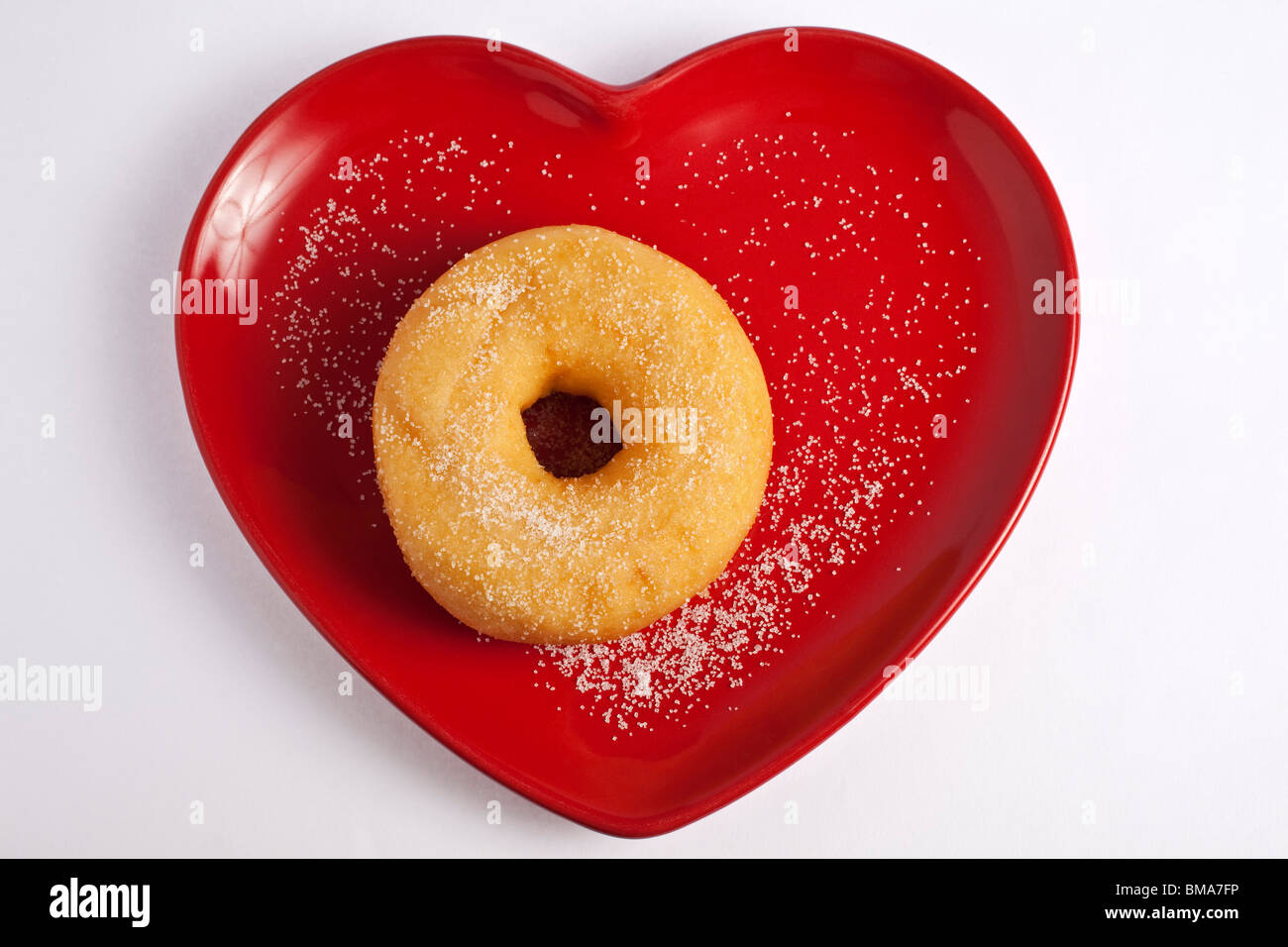 A doughnut on a heart shaped plate Stock Photo - Alamy