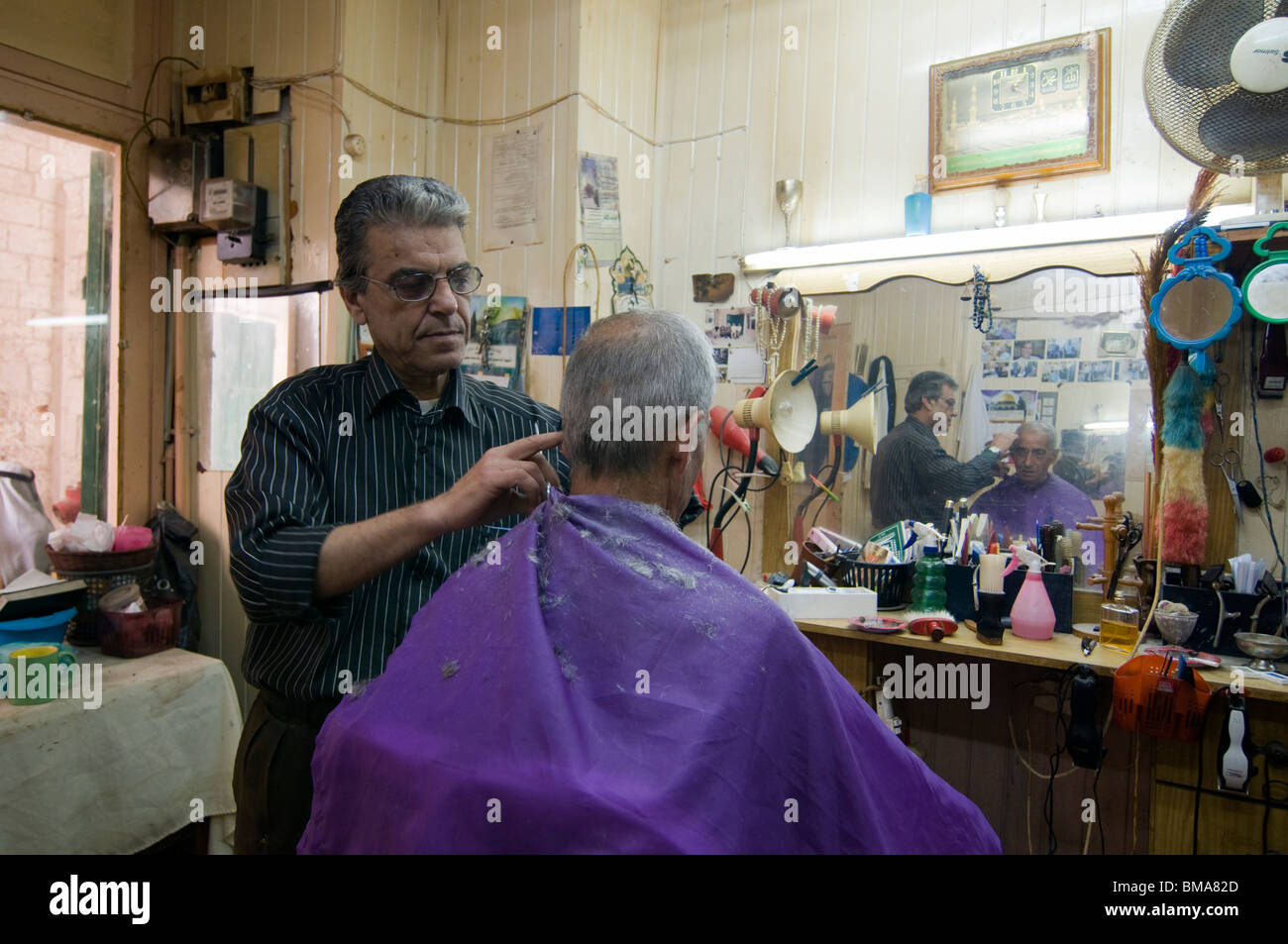 An Israeli Arab having hair cut at the old market in the city of ...