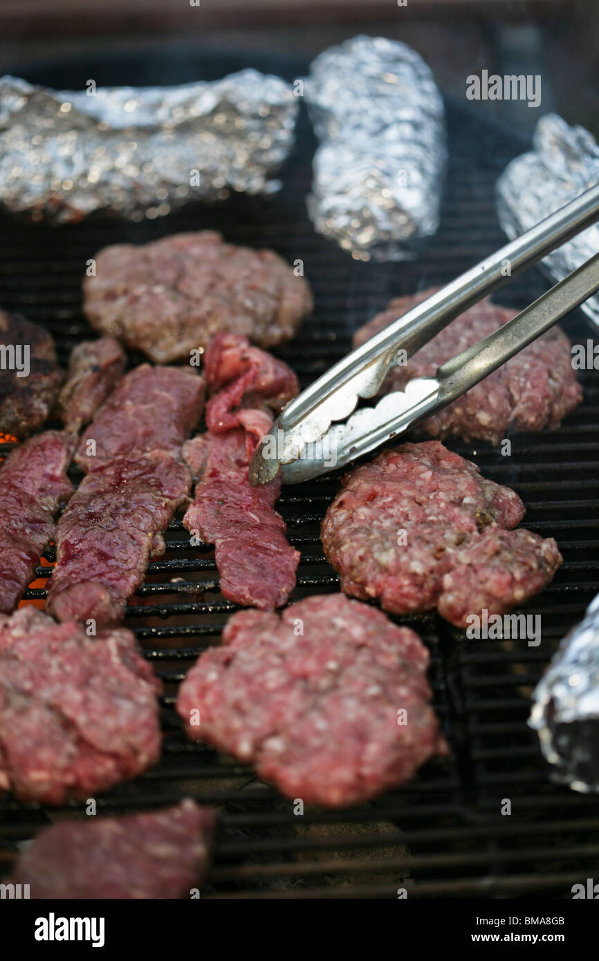 Various meats on a barbecue grill Stock Photo - Alamy