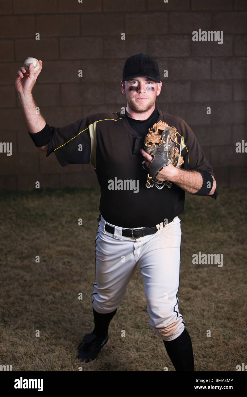 Baseball player fielding and throwing ball Stock Photo - Alamy