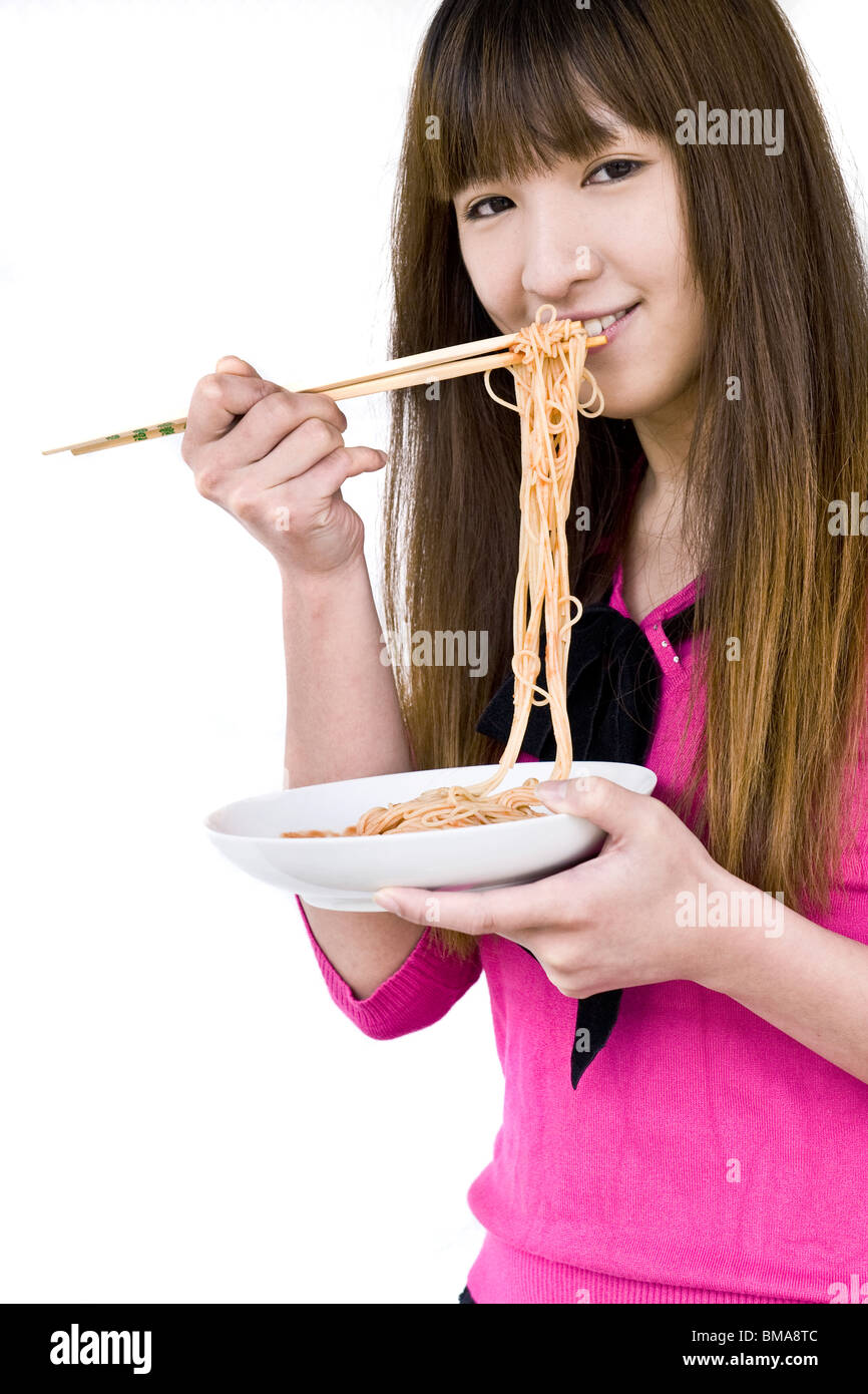 Chinese girl eating spaghetti Stock Photo - Alamy