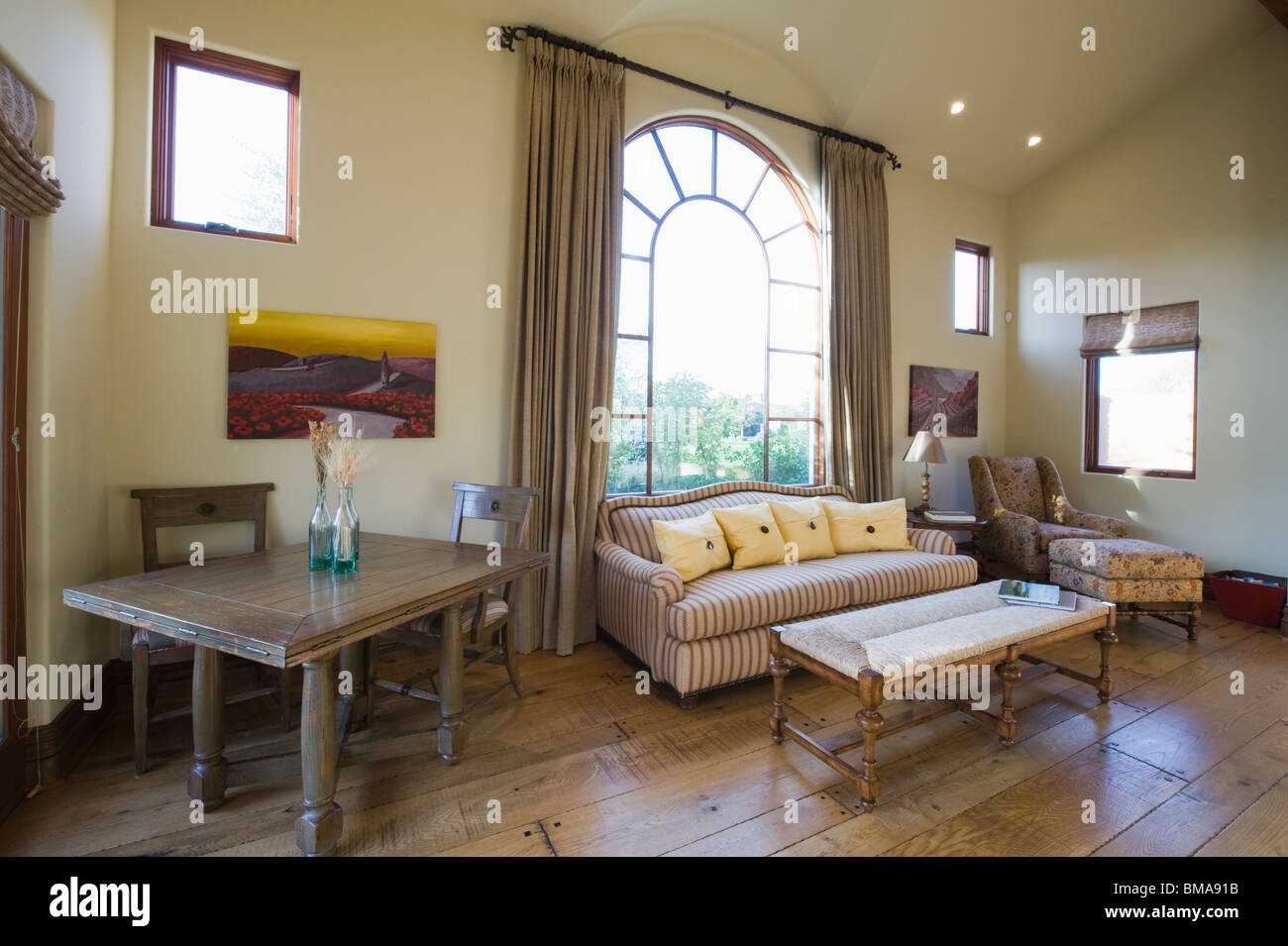 Arched window and sofa in living room with high ceiling Stock Photo - Alamy