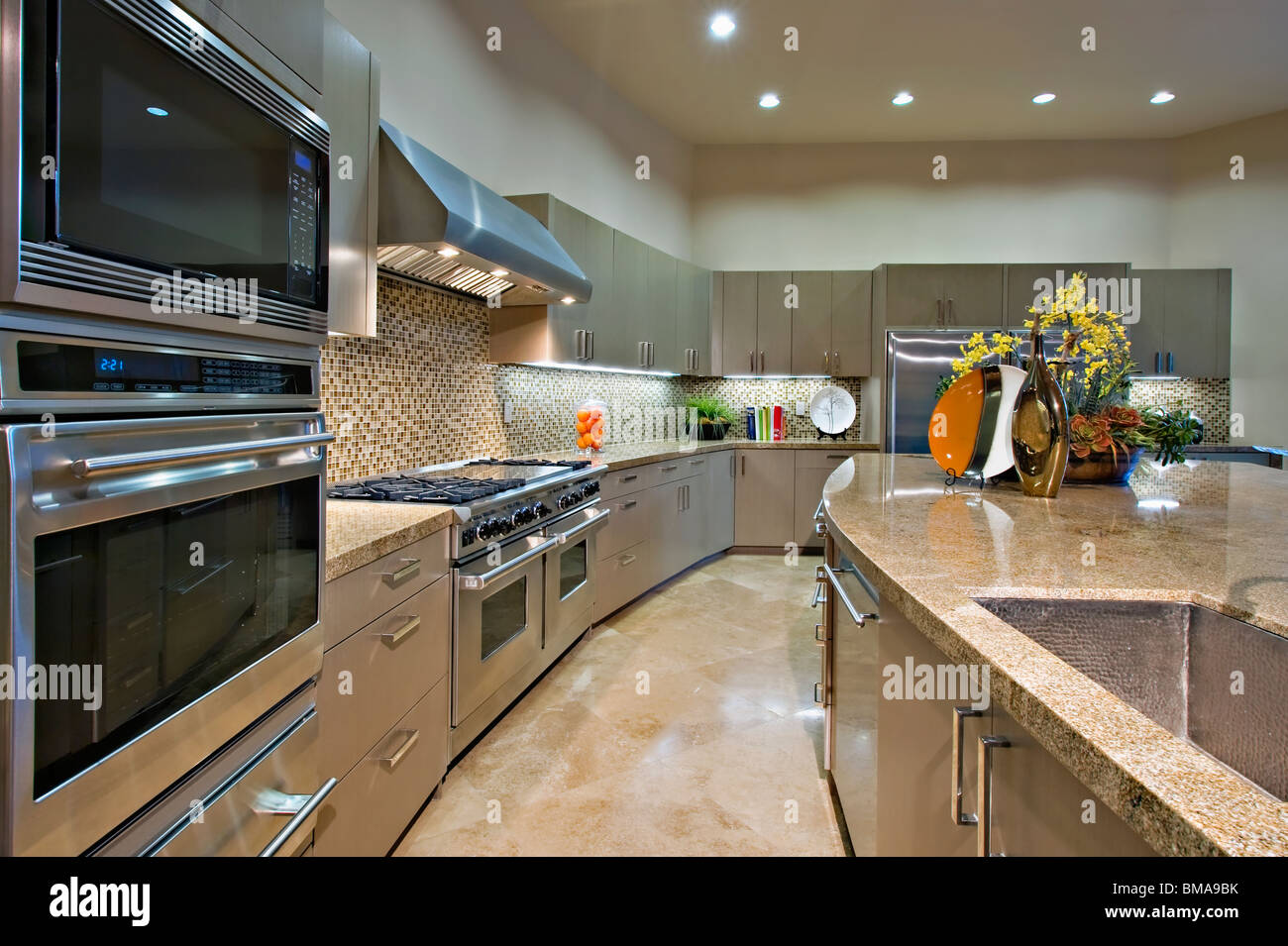 Architecturally designed kitchen with stainless steel fitted units ...
