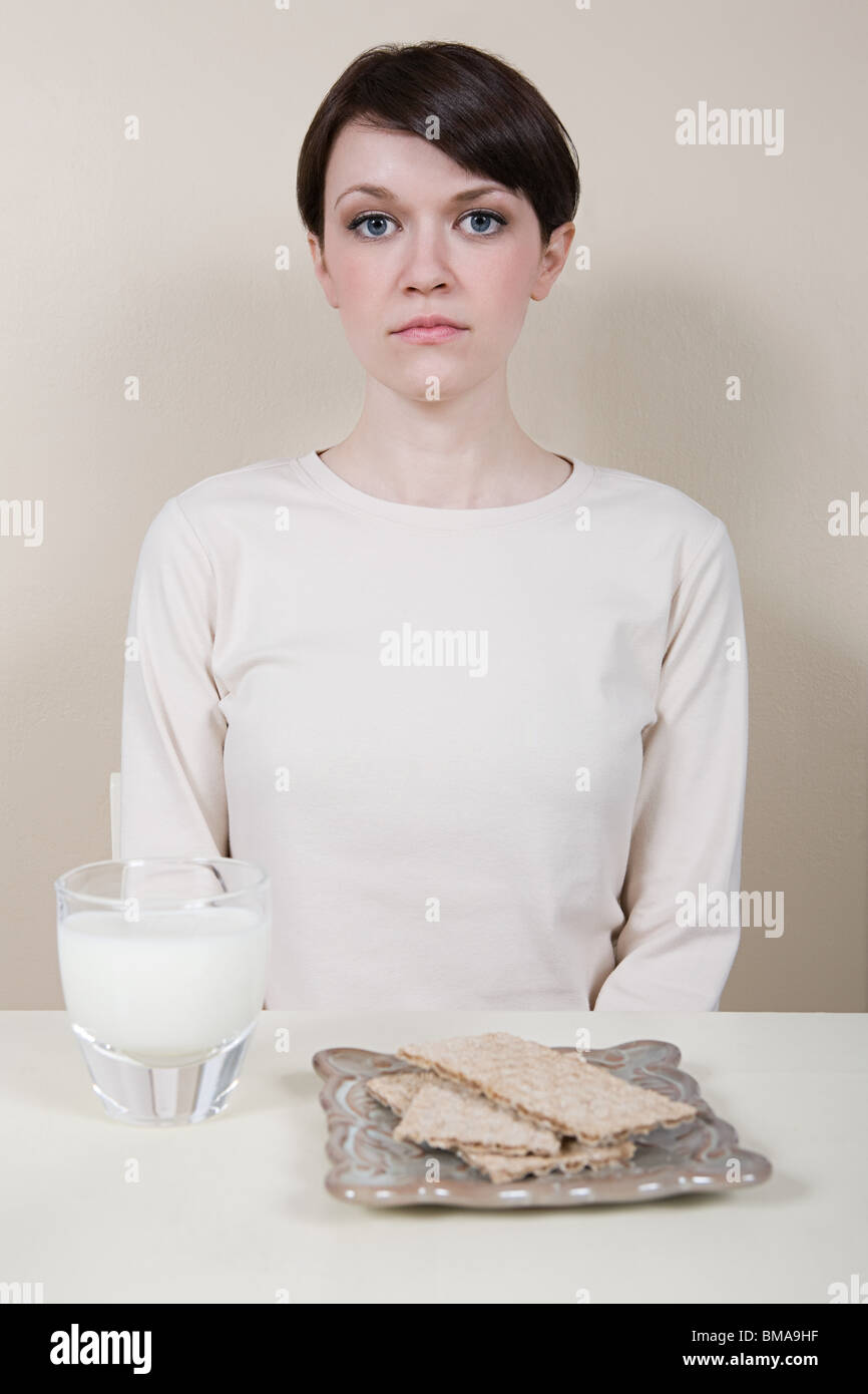 Young woman eating savoury crackers Stock Photo - Alamy