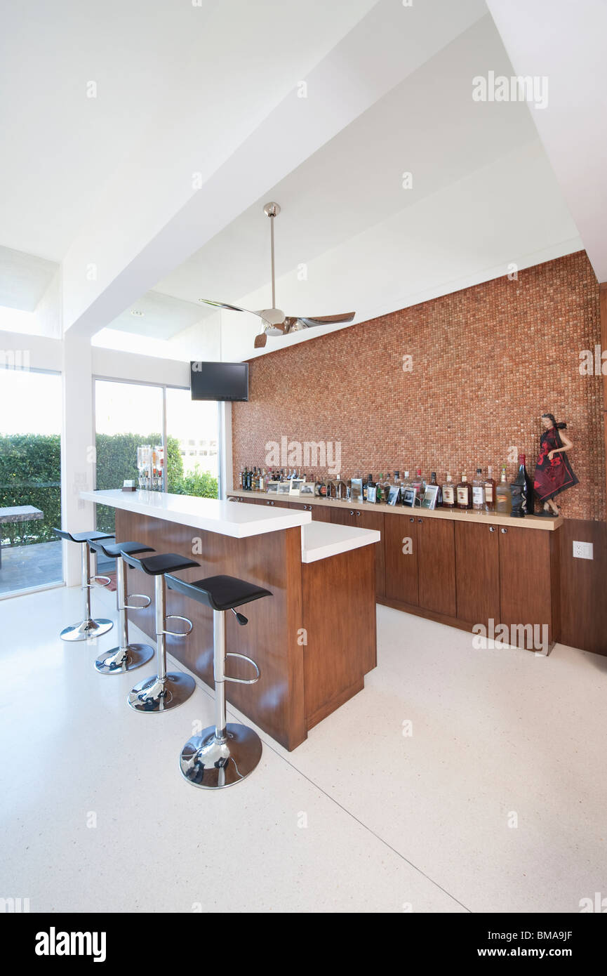 Bar counter and bottles with high white ceiling Stock Photo - Alamy