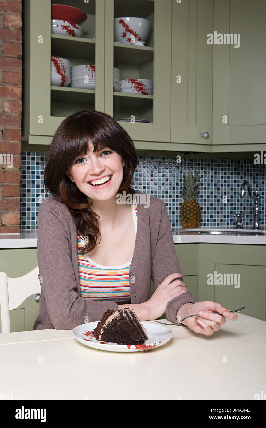 Young woman eating chocolate cake Stock Photo - Alamy