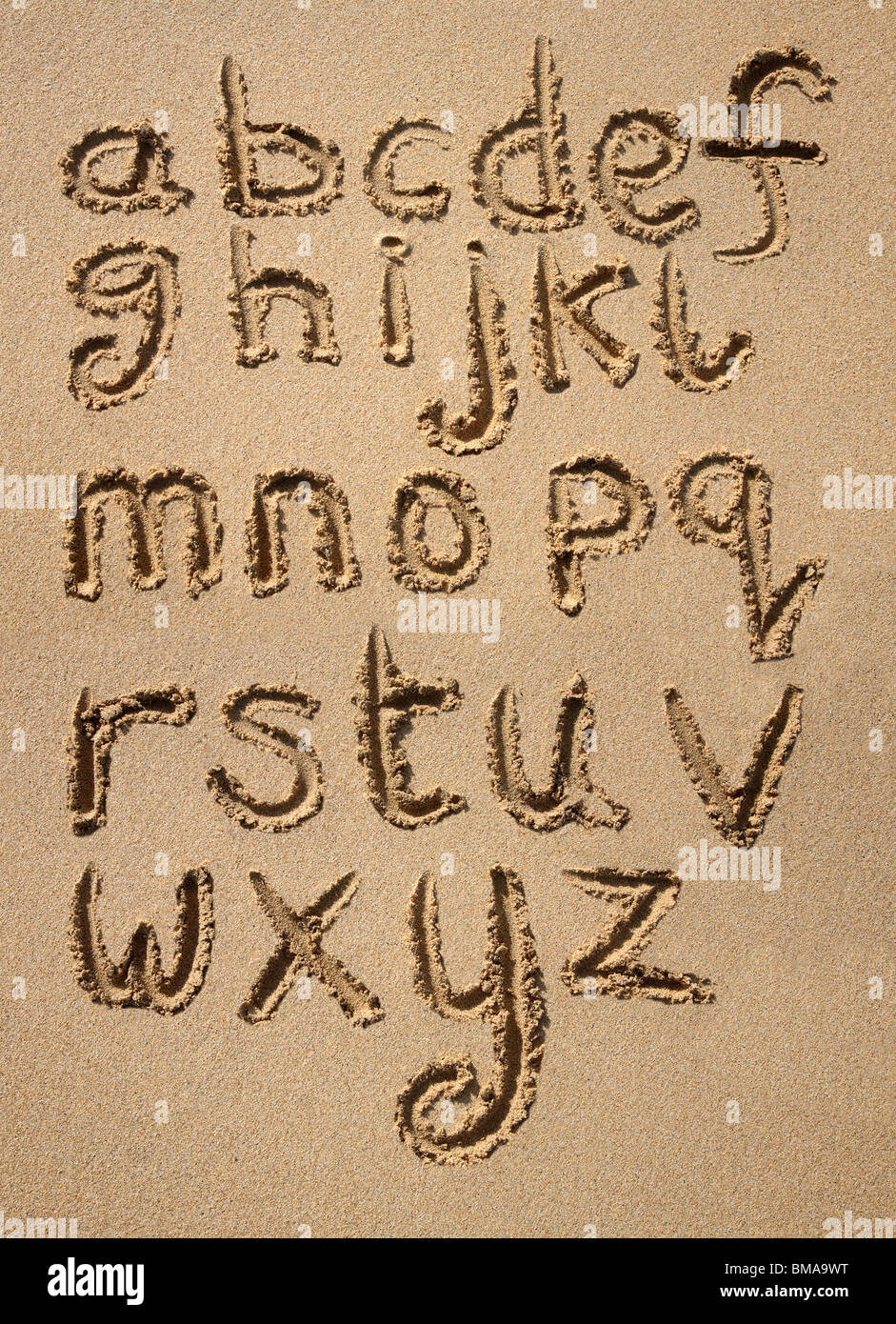 The alphabet written in sand on a beach Stock Photo - Alamy