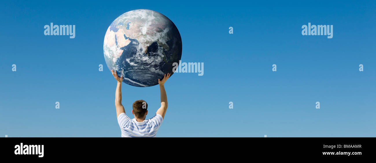 Man holding up earth Stock Photo - Alamy