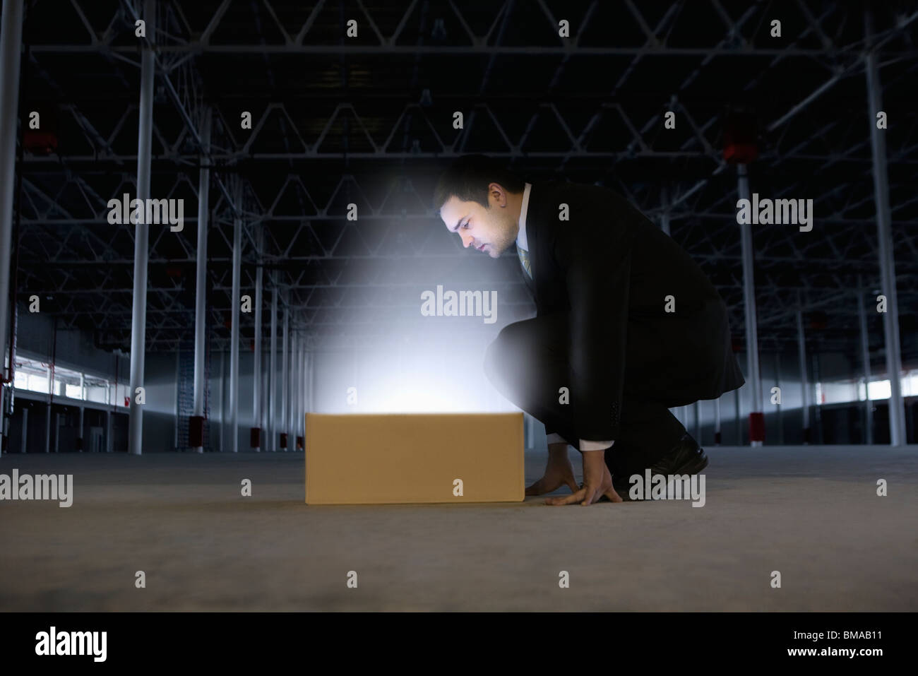 Man peers into yellow box shining bright light Stock Photo - Alamy