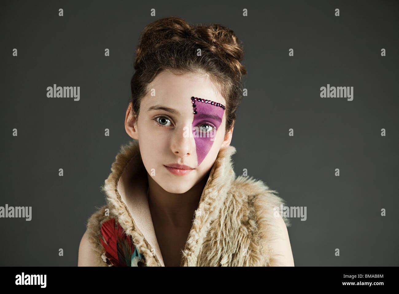 Young girl wearing purple face paint Stock Photo - Alamy