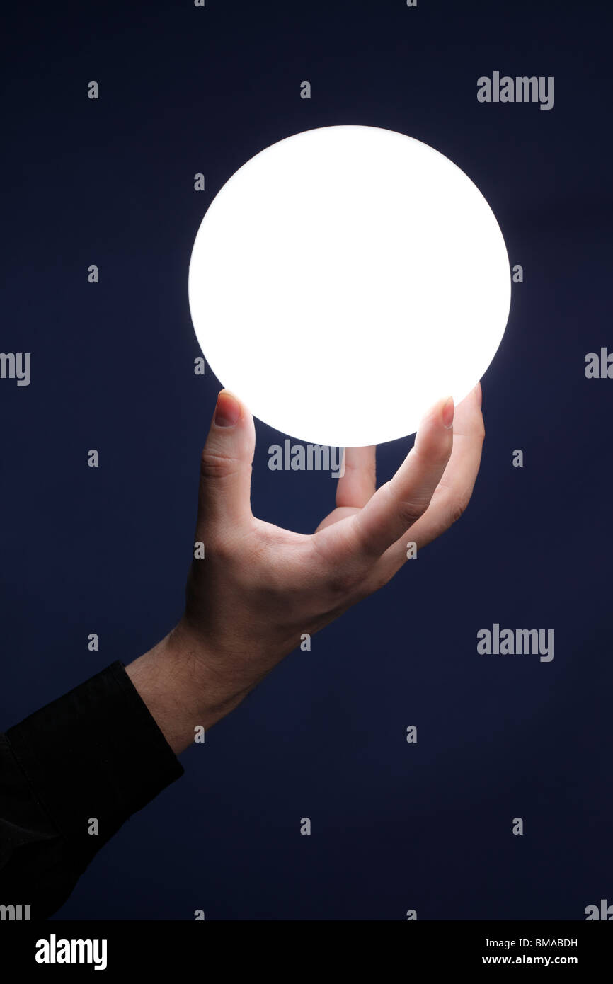 Man holding an illuminated sphere Stock Photo - Alamy