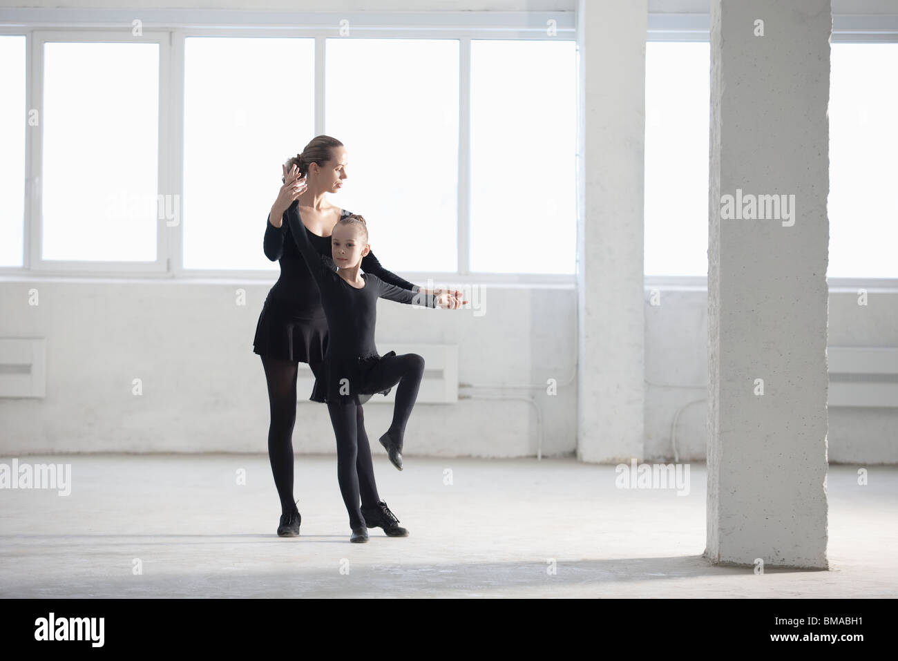 Woman and girl practise dance moves Stock Photo - Alamy
