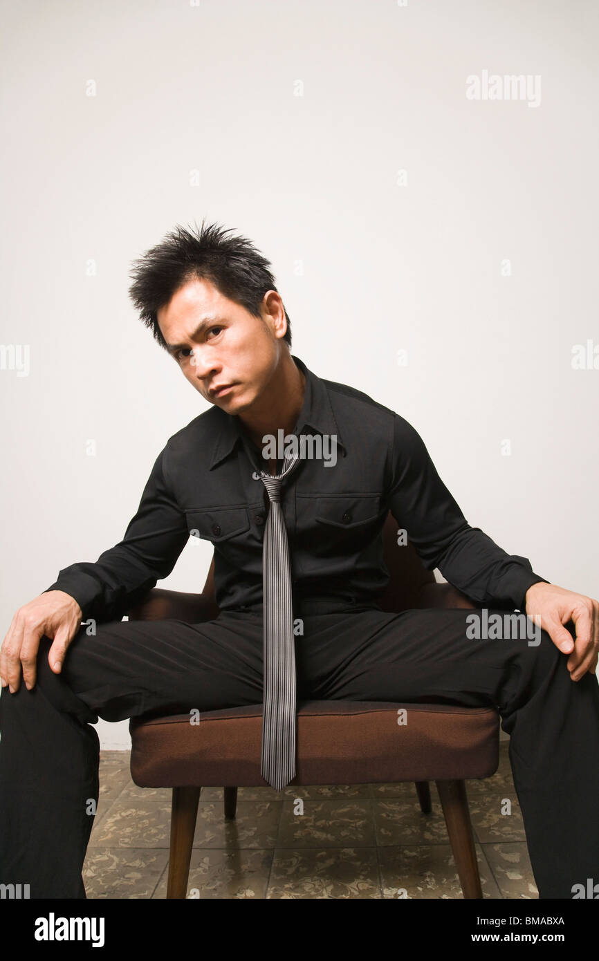 Angry Businessman Sitting on Chair Stock Photo - Alamy