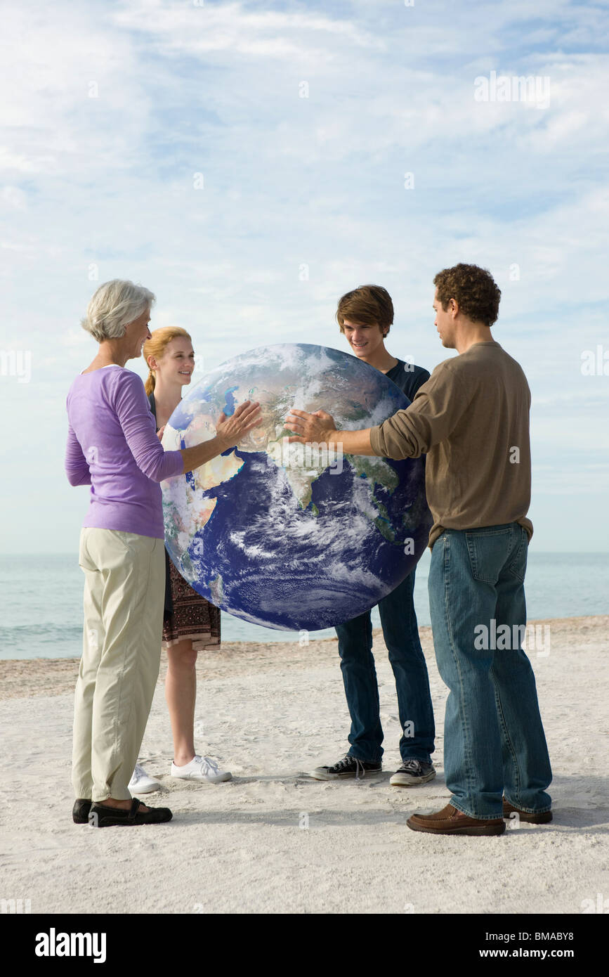 Ecology concept, four people placing hands on earth together Stock ...