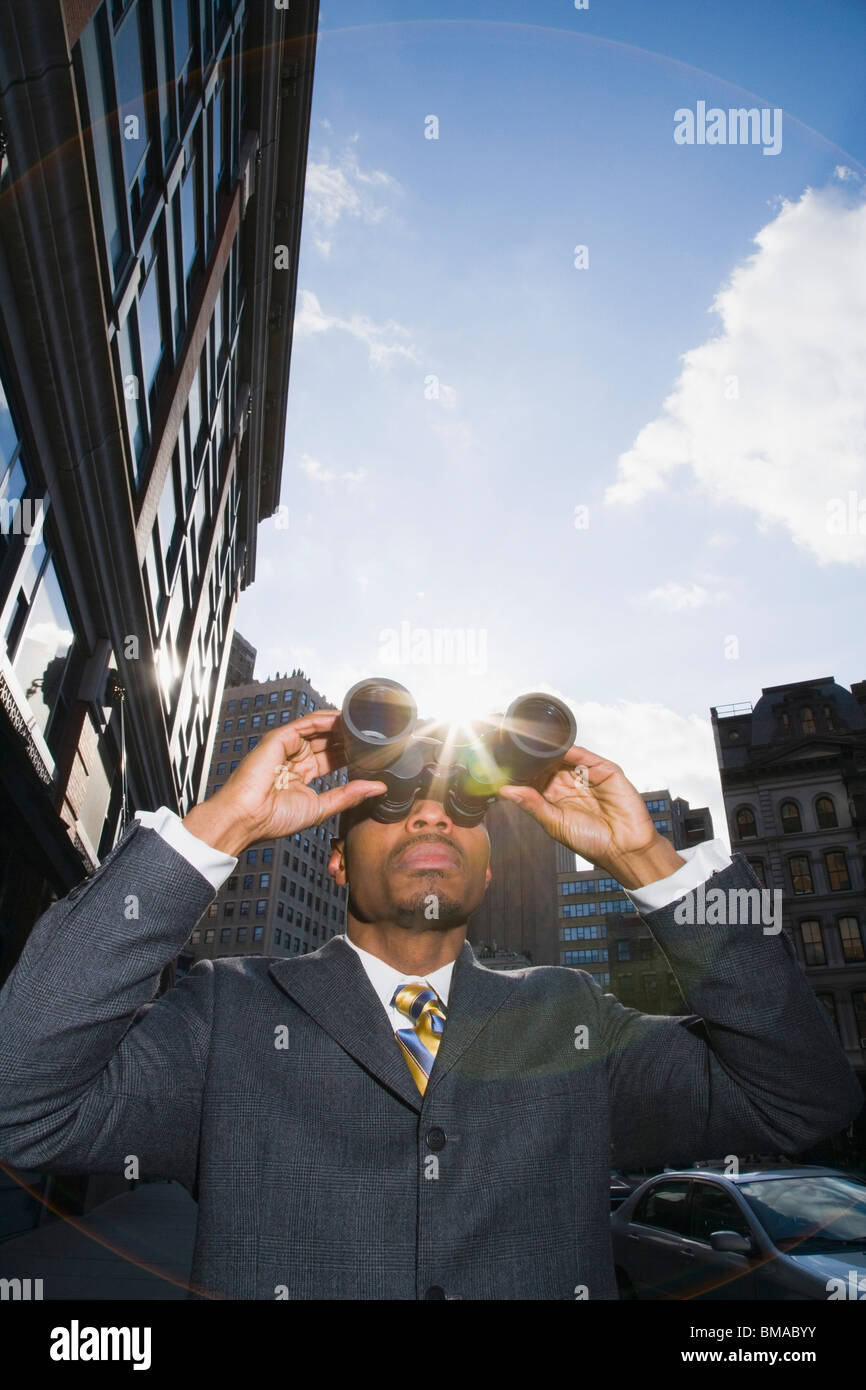 Businessman Looking Through Binoculars Stock Photo - Alamy Businessman Looking Through Binoculars Stock Photo - Alamy