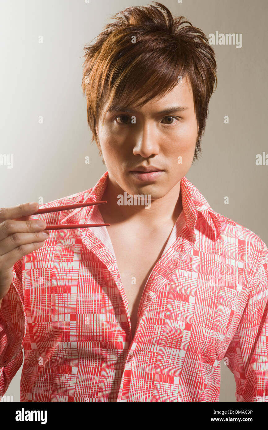 Portrait of Man Holding Chopsticks Stock Photo - Alamy