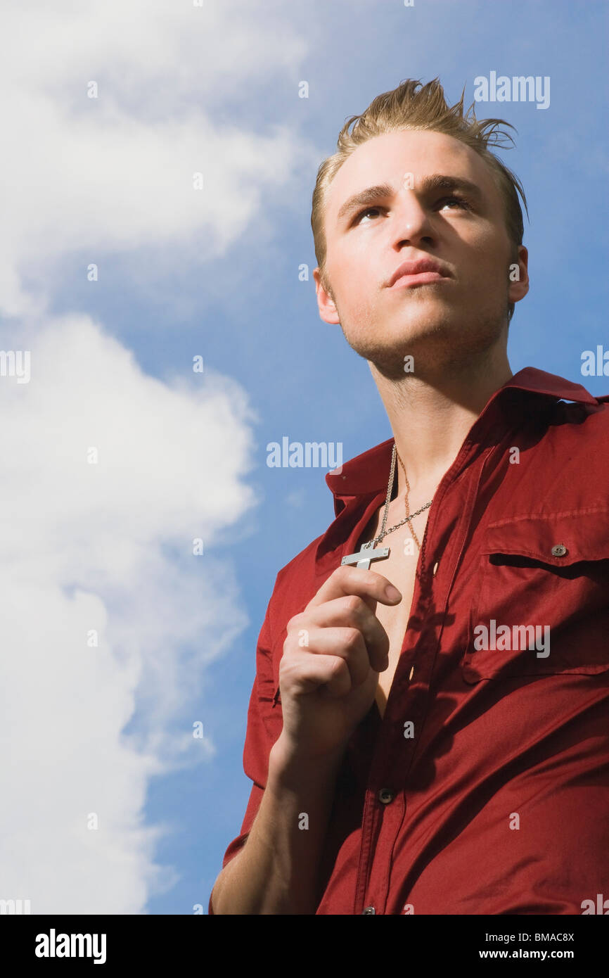 Man Holding Cross on Chain Stock Photo - Alamy