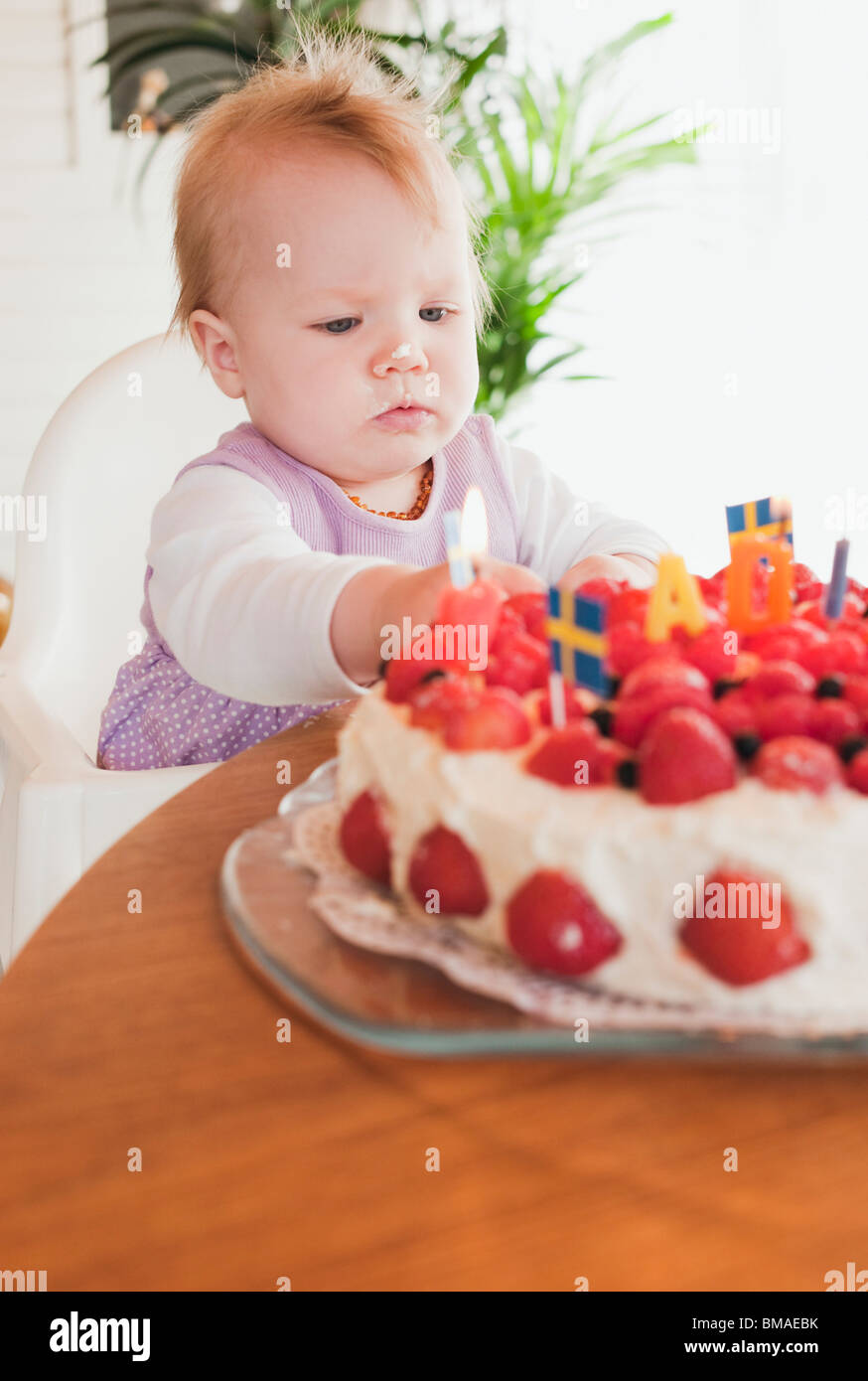 Little Girl Looking at Cake Stock Photo - Alamy