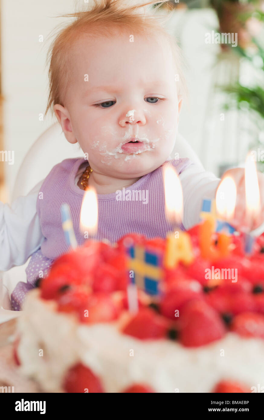 Little Girl Looking at Cake Stock Photo - Alamy