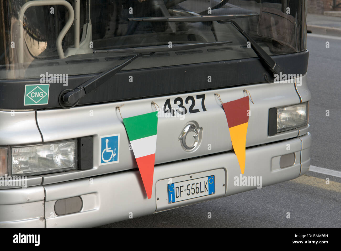 Rome, Italy. A bus carrying the Italian flag (left) and the Roman flag ...