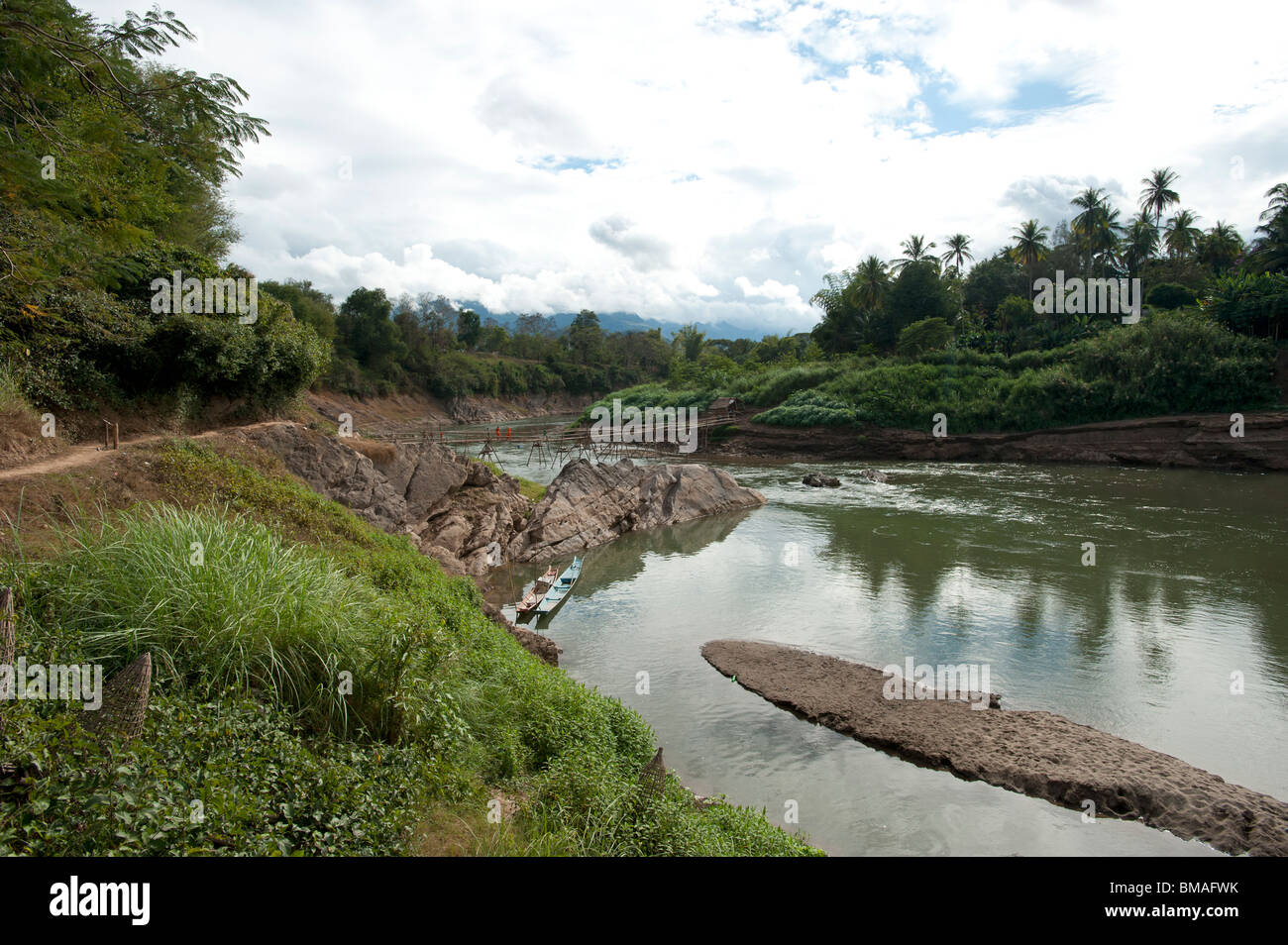 A Bamboo Bridge Spans The Nam Khan River At The Confluence With The