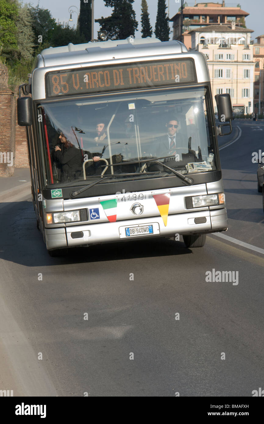 Rome, Italy. A bus carrying the Italian flag (left) and the Roman flag ...