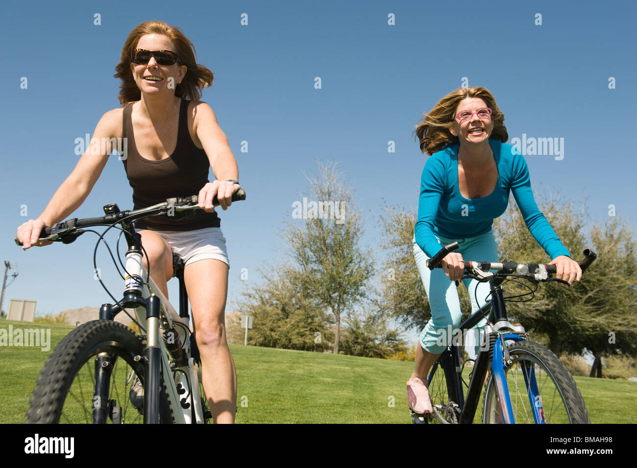 Two friends cycle side by side Stock Photo - Alamy