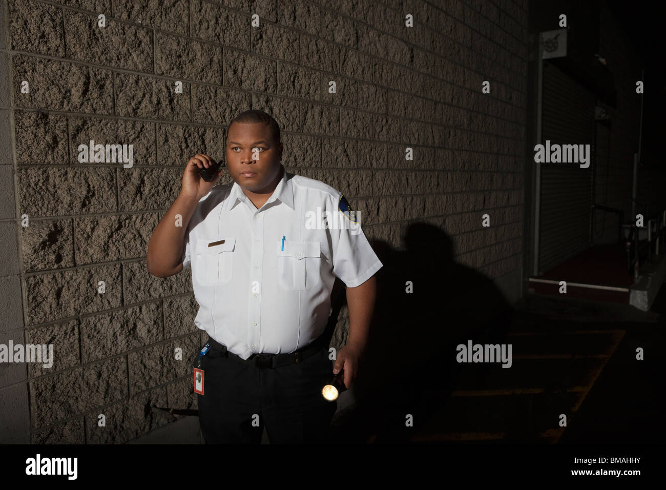 Security guard patrols with torch Stock Photo - Alamy