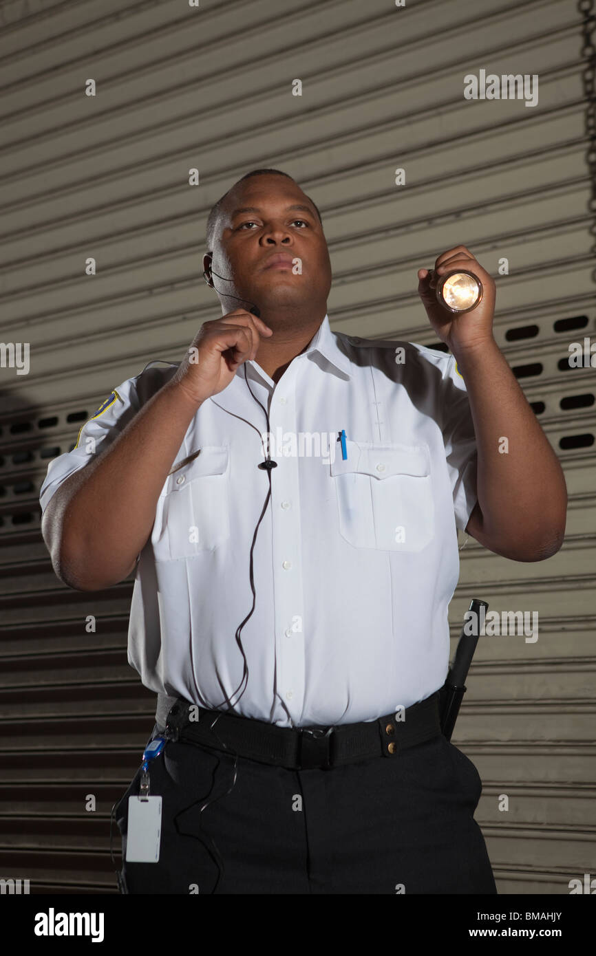 Security guard patrols with torch Stock Photo - Alamy