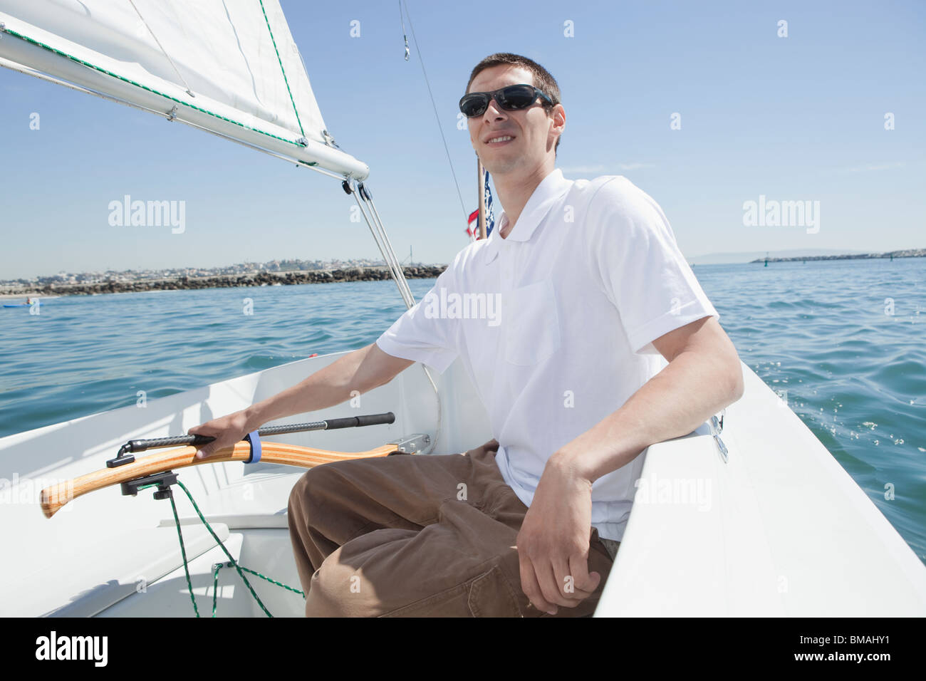 Young man sailing Stock Photo - Alamy