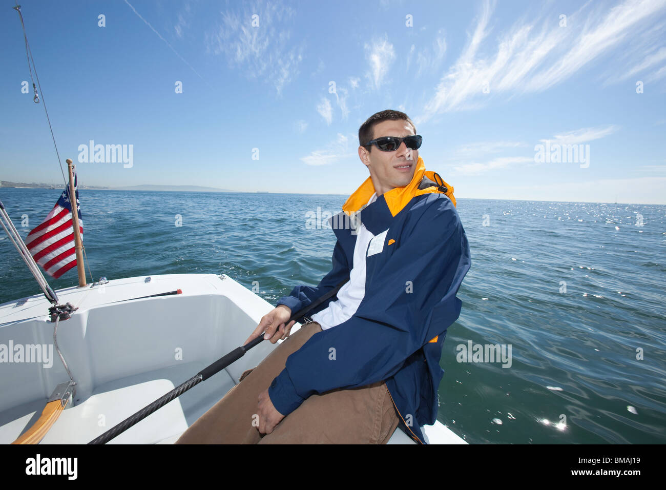 Young man sailing Stock Photo - Alamy