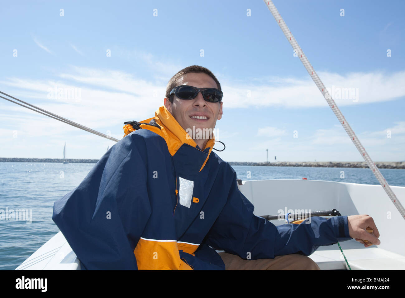 Young man sailing Stock Photo - Alamy