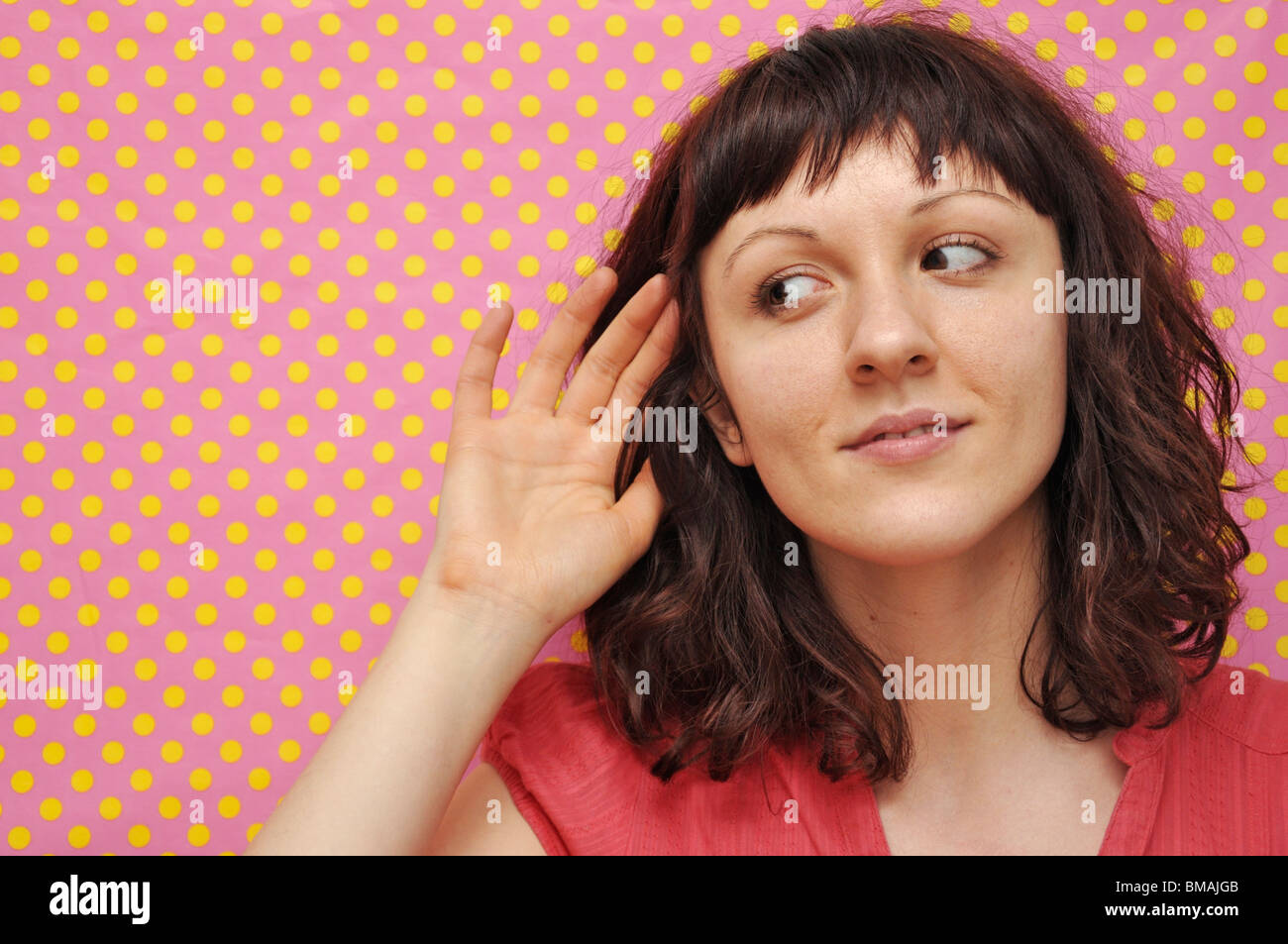 Young woman eavesdropping Stock Photo - Alamy