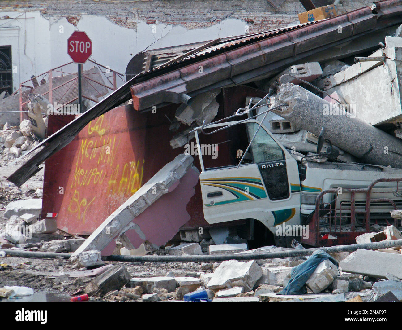 STOP sign in the rubble by a crushed lorry in Port au Prince after the ...