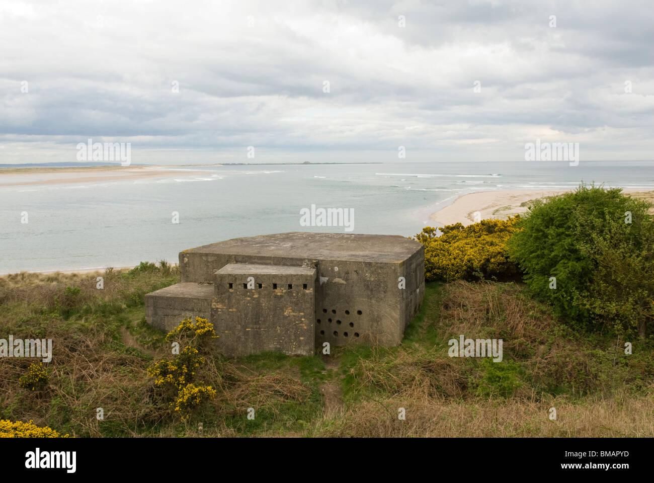 A World War II pillbox, used for sea defense. Budle Bay beach ...
