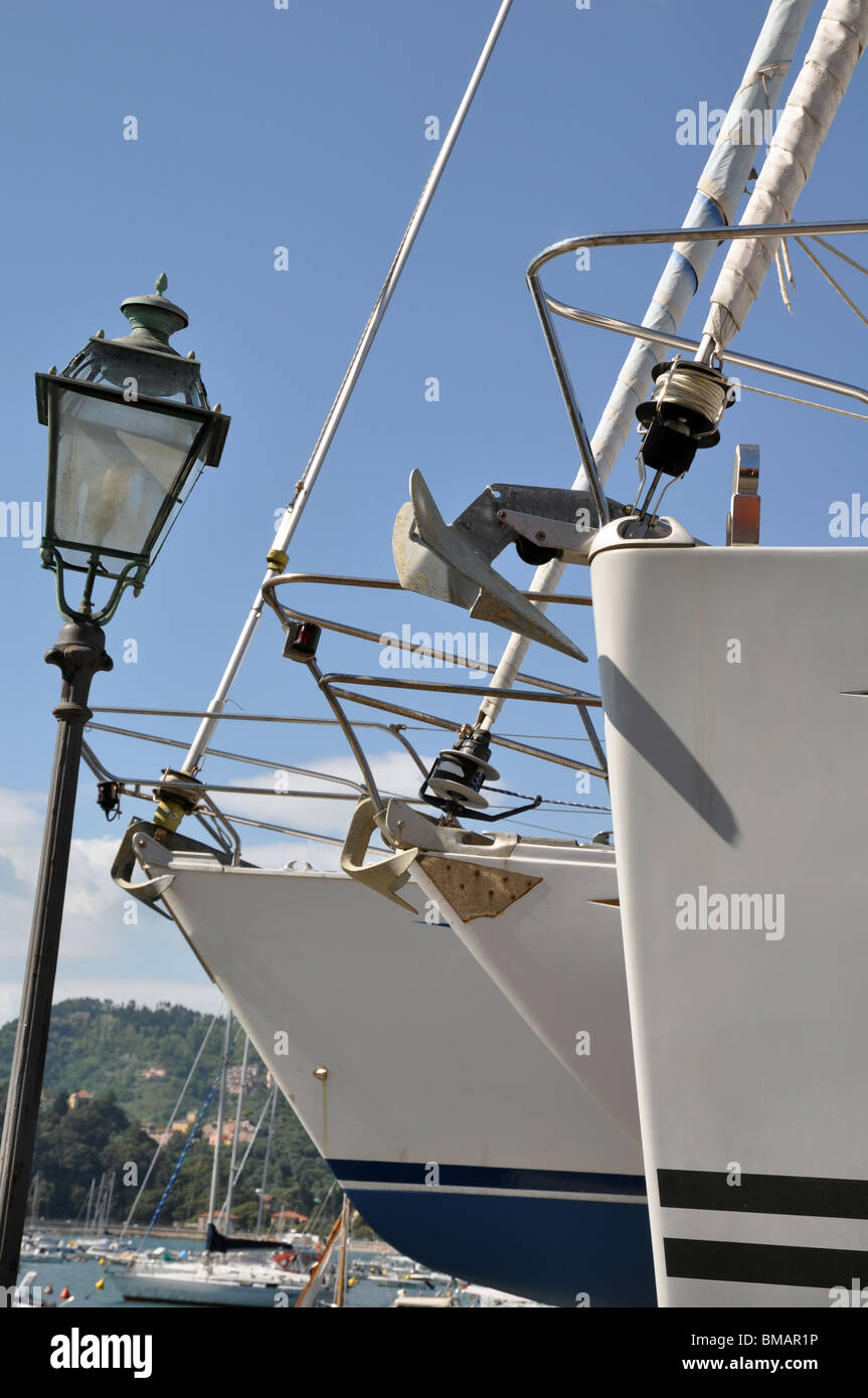 the prow of three sailboats in a dockyard Stock Photo - Alamy