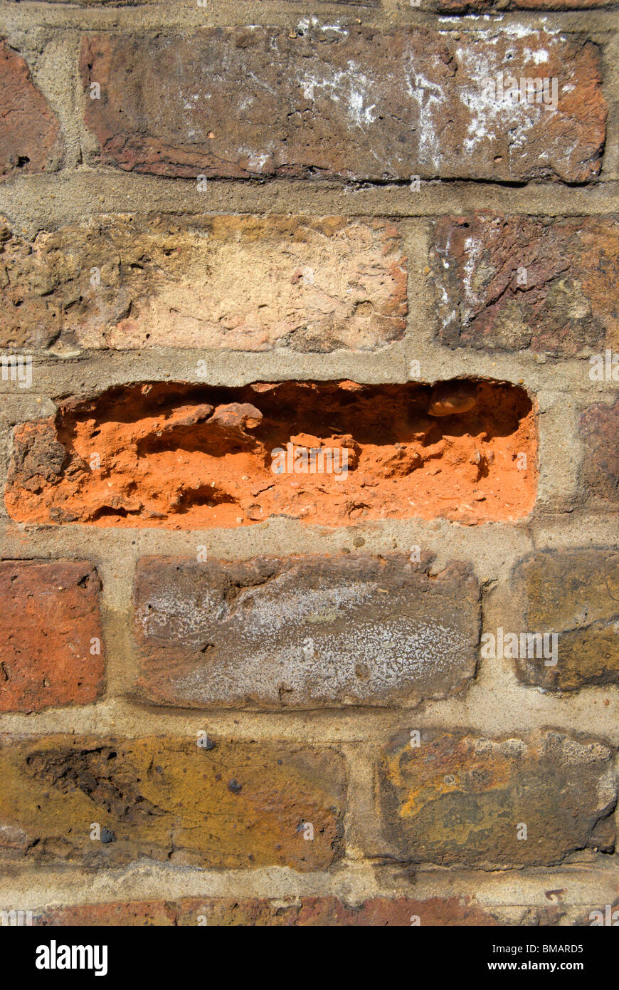 spalled brick in a brick wall Stock Photo - Alamy