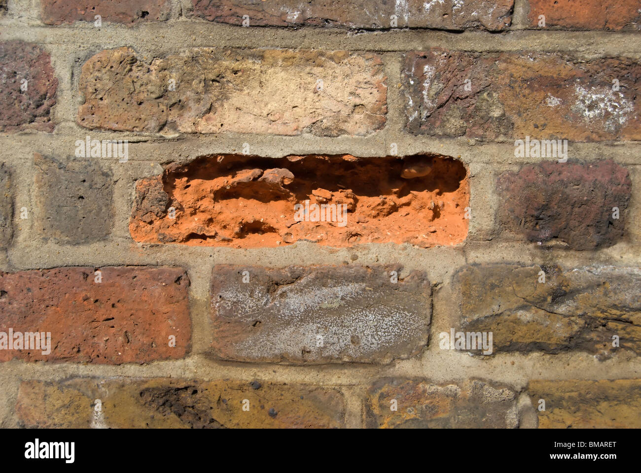spalled brick in a brick wall Stock Photo - Alamy