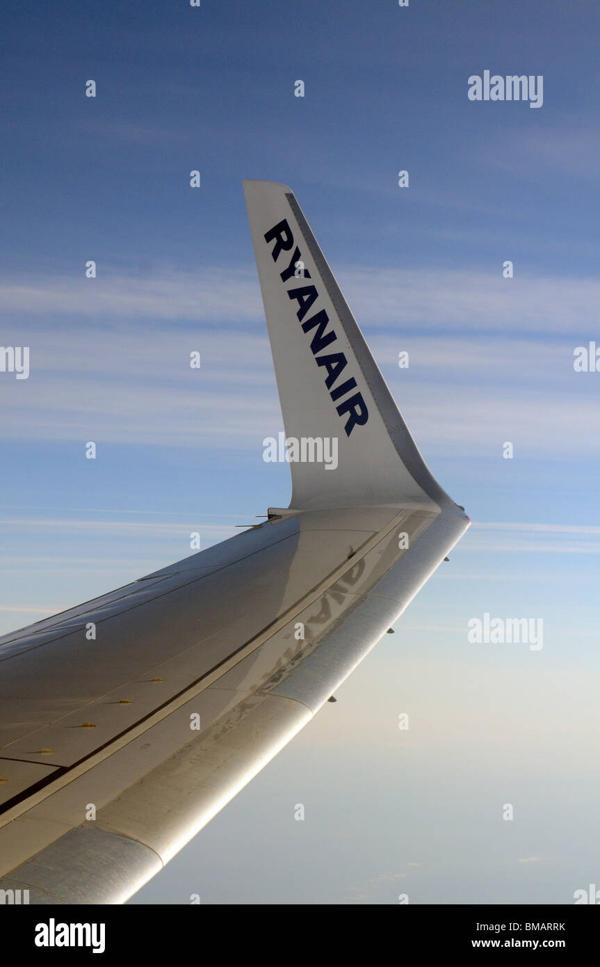 Aircraft winglet carrying the name Ryanair a low cost European airline and open skies backdrop ...
