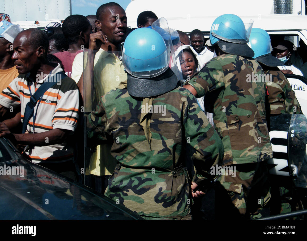 United Nations (MINUSTAH) peaekeepers scuffle with civilians waiting ...